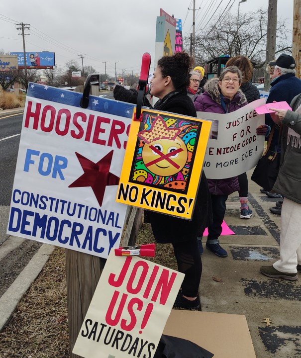 Anti-ICE protesters line 86th Street with signs