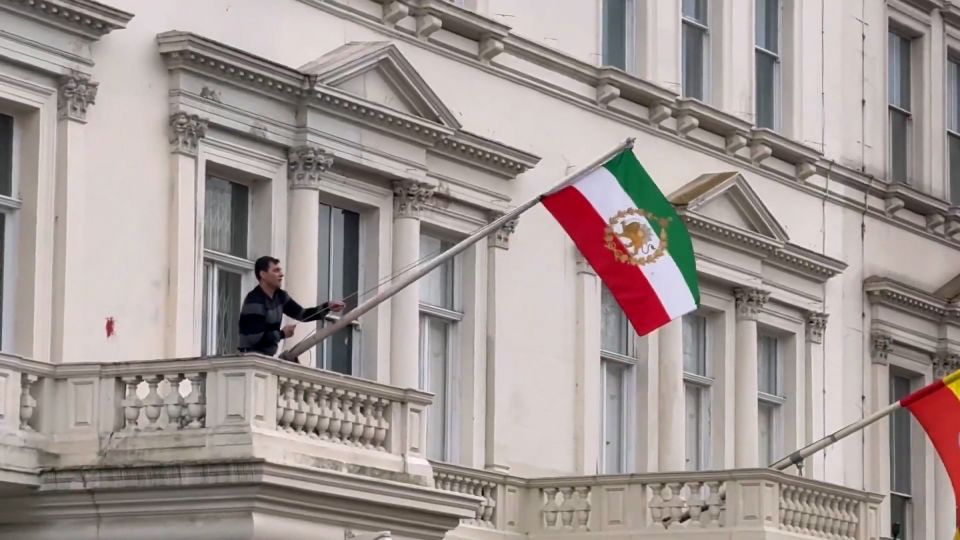 Protester tears down Iranian flag at embassy in London