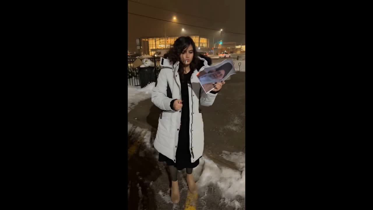 Iran protester lights cigarette from burning Ayatollah poster in Tehran ...