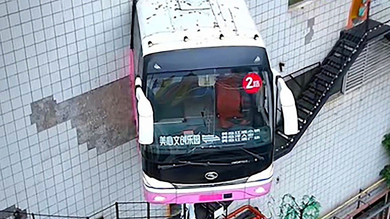 Bus appears to burst through buildings in striking display