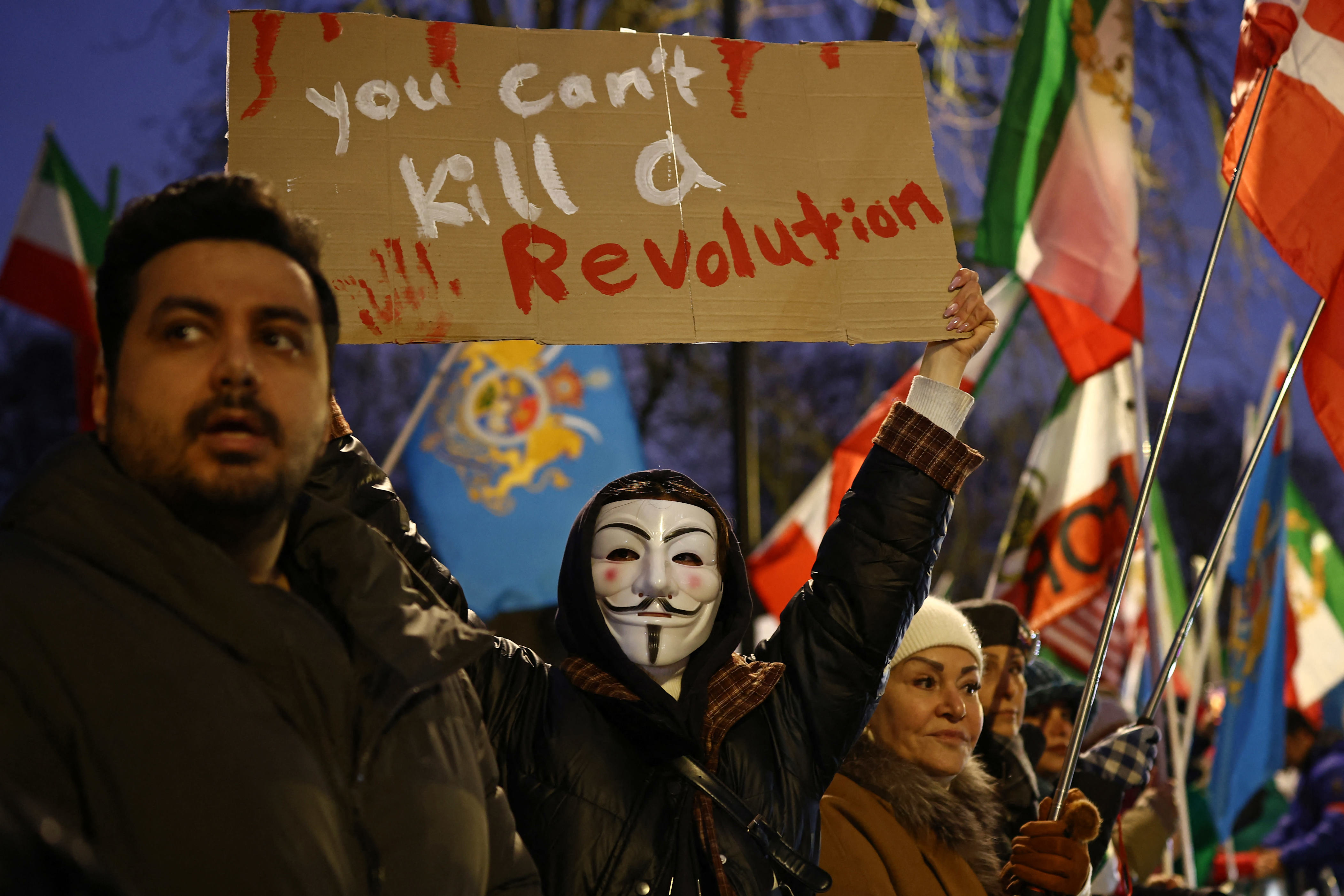 Protester tears down flag at Iranian embassy in London - report