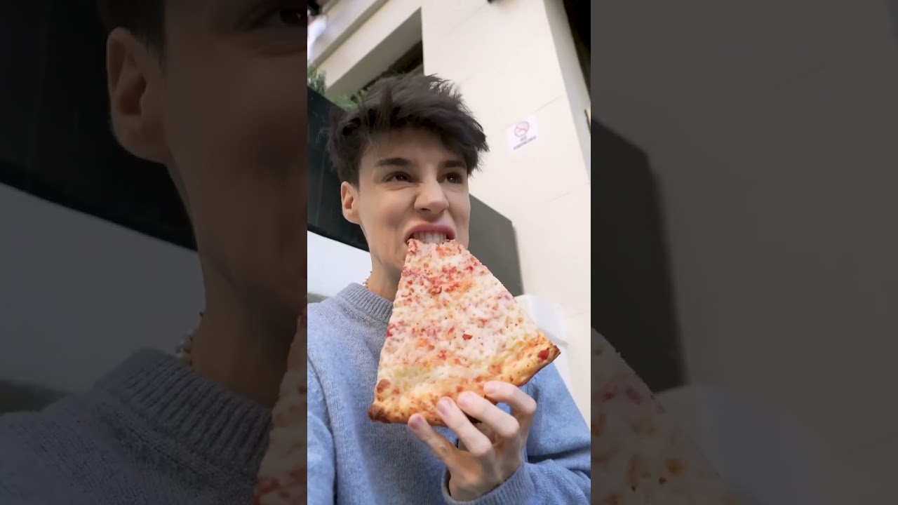 Foreign traveler reviews famous one dollar New York City pizza slice