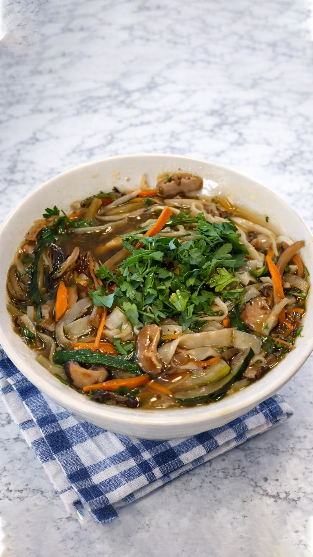 Cooking warm and hearty vegan kal-guksu soup