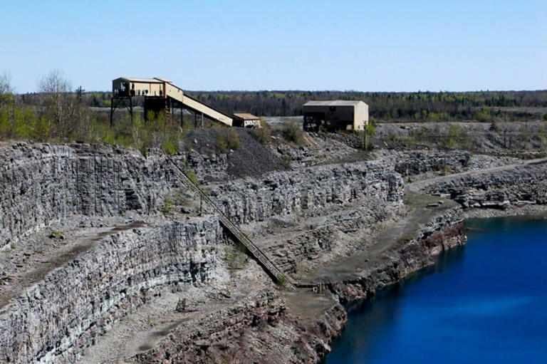 A 220-meter-deep hole left by an iron mine is now a turquoise lake with ...