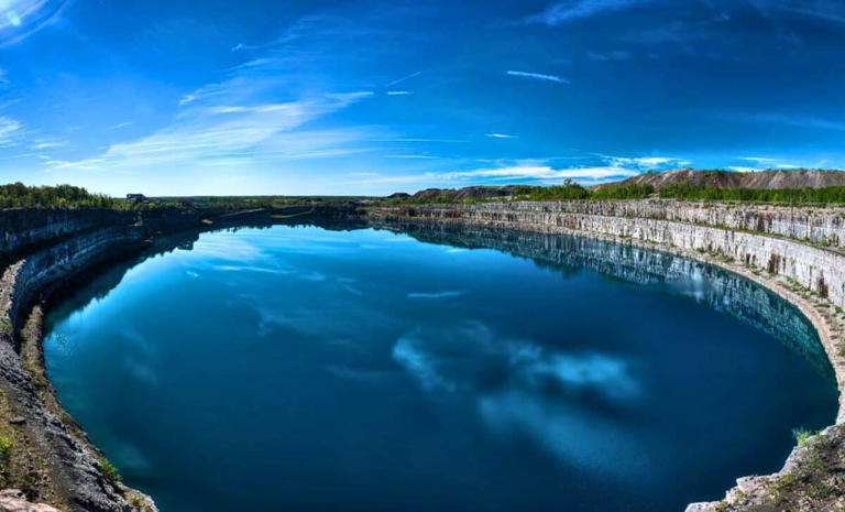 A 220-meter-deep hole left by an iron mine is now a turquoise lake with ...