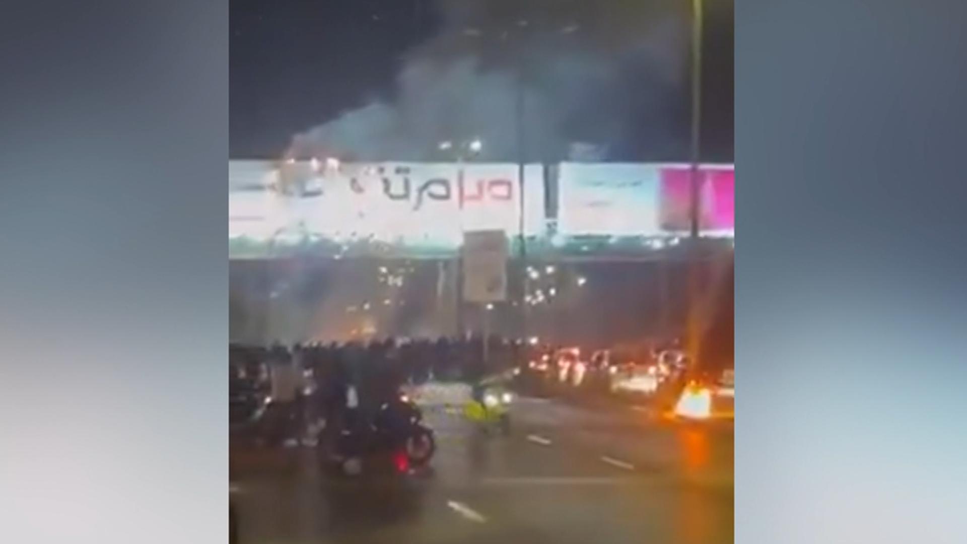 Iran protesters set banner on fire | Raw video