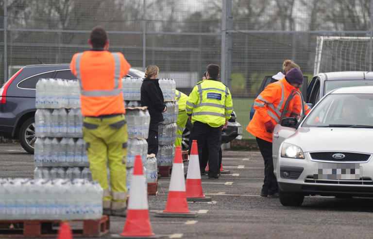 In photos: cars queue at bottled water station in East Grinstead as ...