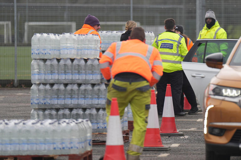 In photos: cars queue at bottled water station in East Grinstead as ...