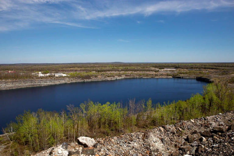 A 220-meter-deep hole left by an iron mine is now a turquoise lake with ...
