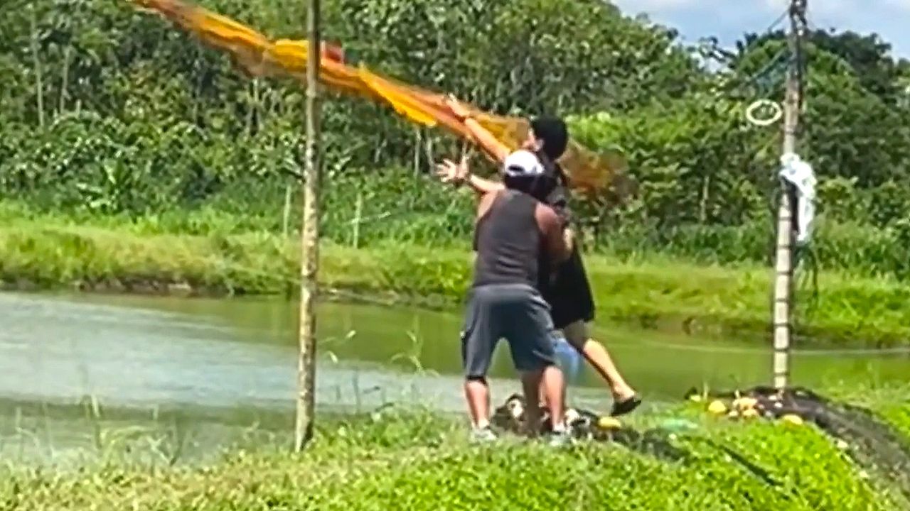 Fishermen send net and themselves into pond