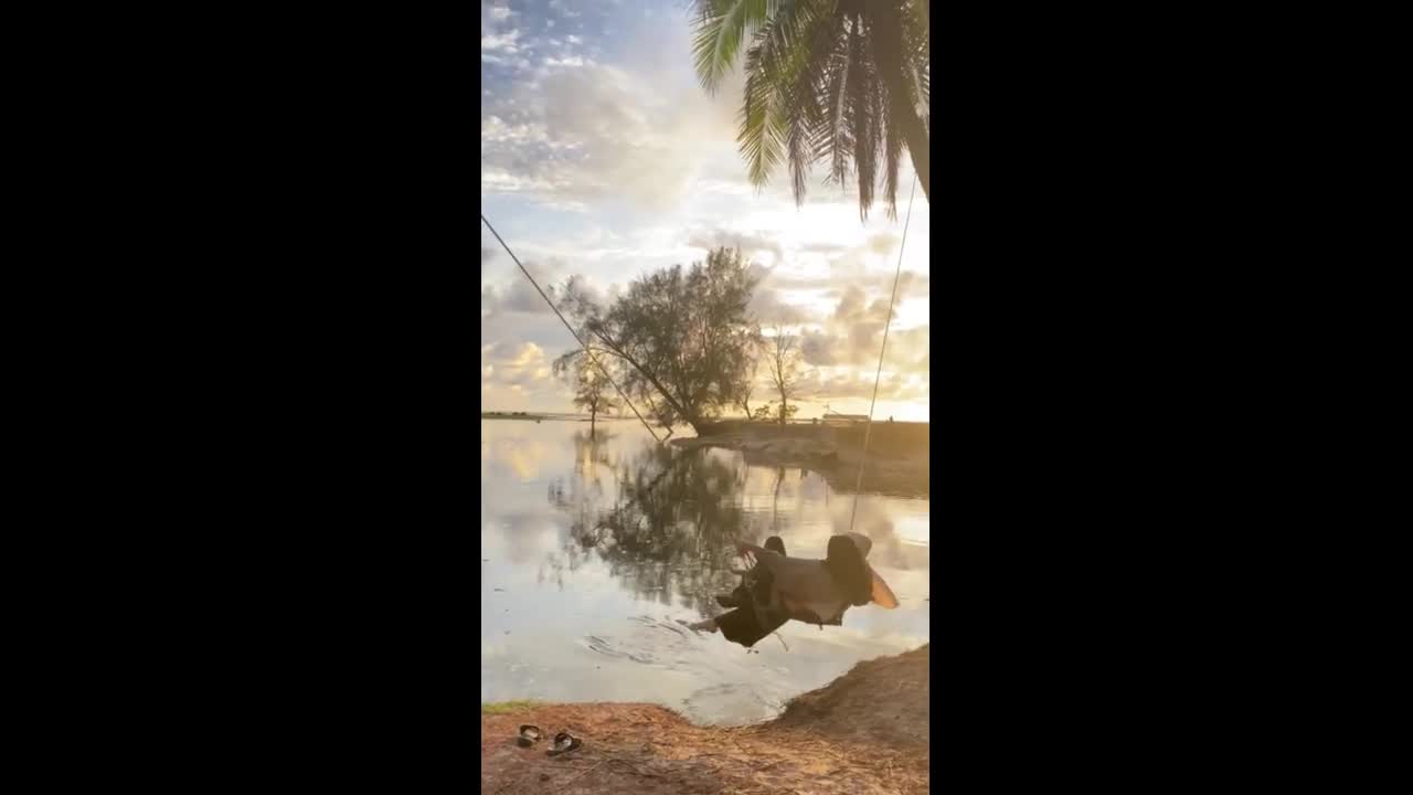 Swing mishap sends two friends into the lake in Muaro Mati, Indonesia