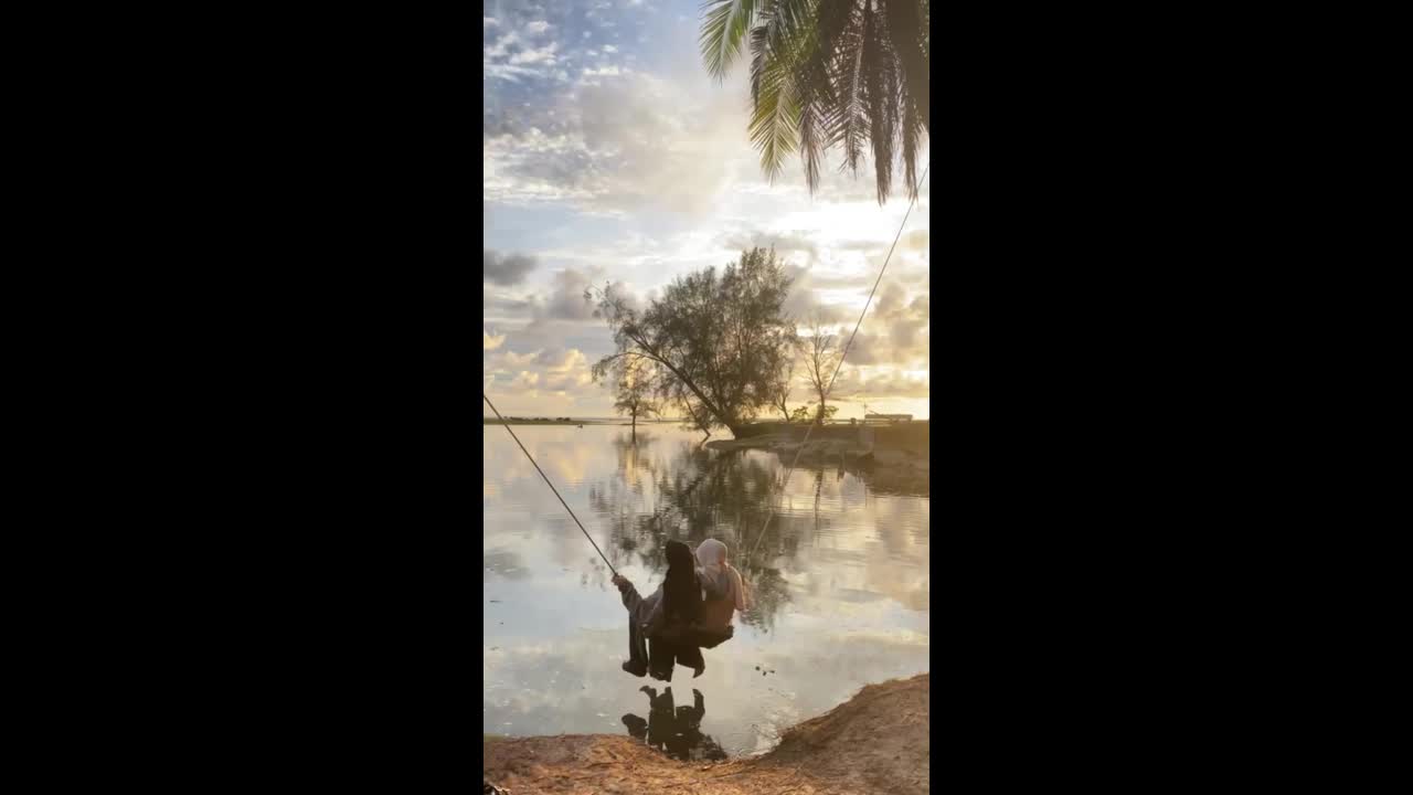 Swing mishap sends two friends into the lake in Muaro Mati, Indonesia