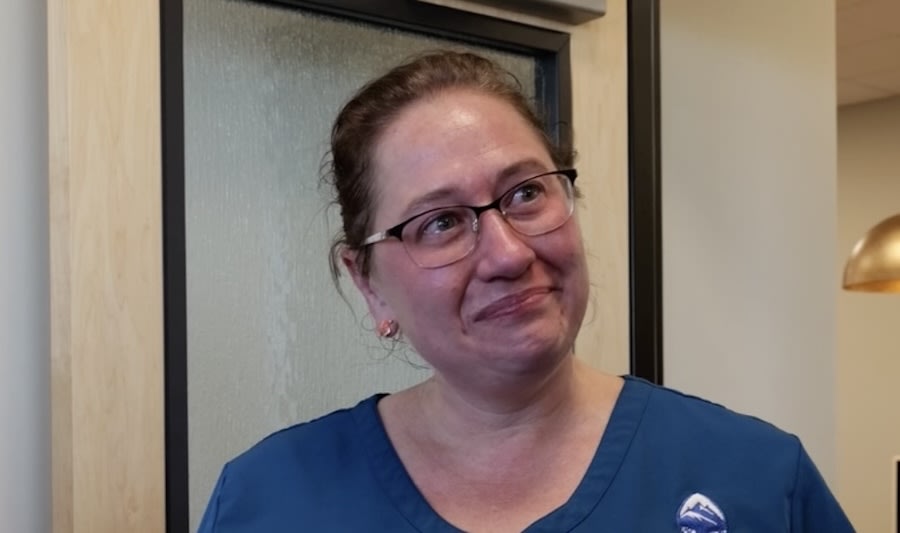 Woman surprised at work with gift from a secret Santa