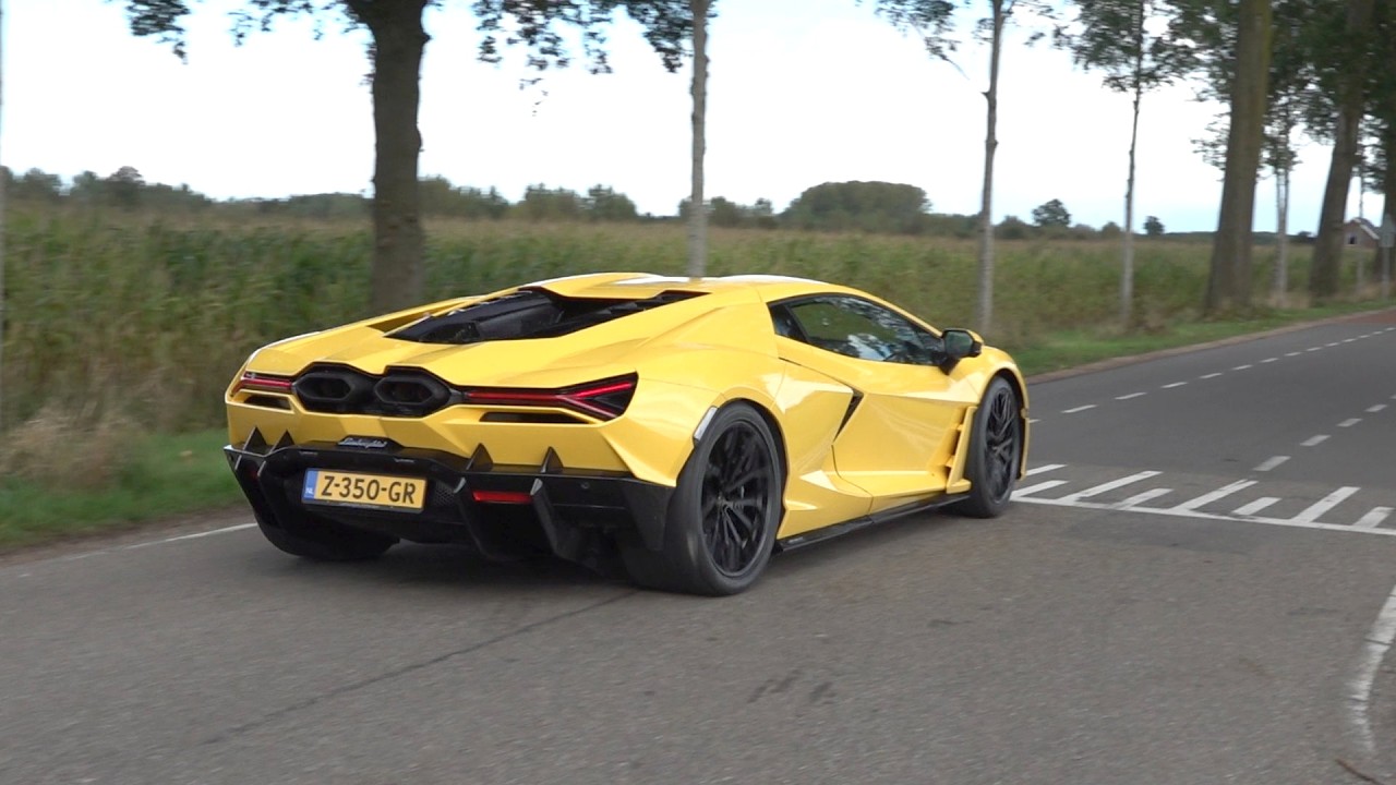 Yellow Lamborghini driving smoothly on a country road