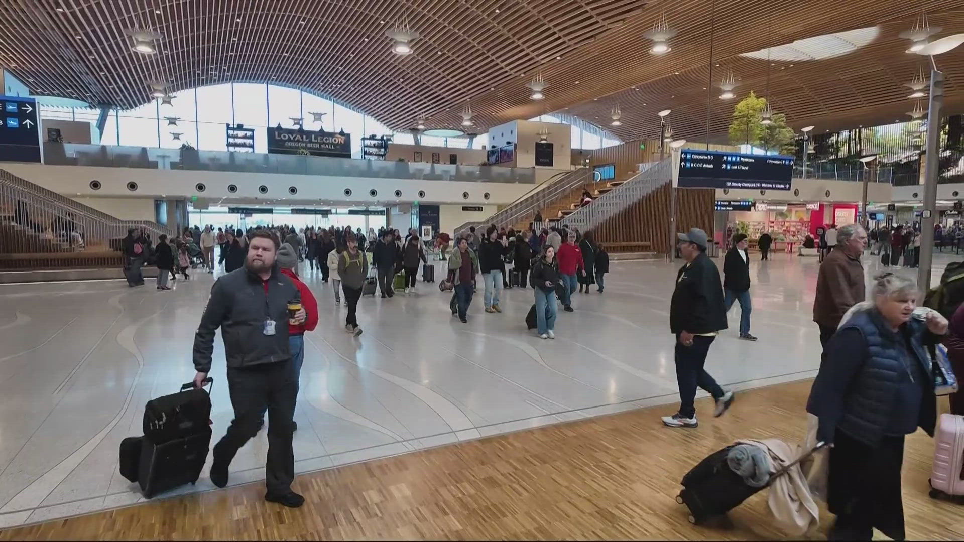 Holiday travel crowds pack PDX as millions fly nationwide