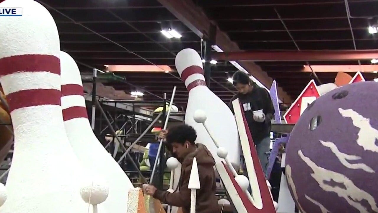 Volunteers decorate Rose Parade floats in Pasadena