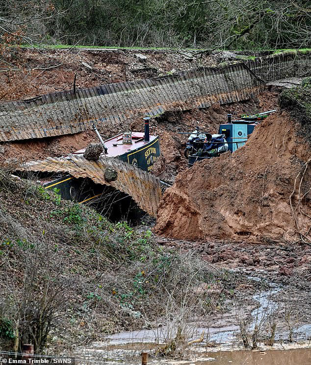 Workers attempt to rescue three narrowboats dragged to the depths by ...