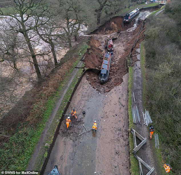Workers attempt to rescue three narrowboats dragged to the depths by ...