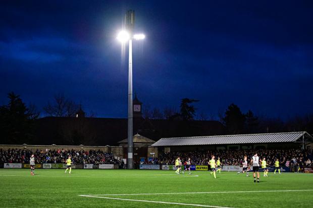 Fan trouble during football derby as flare thrown onto pitch