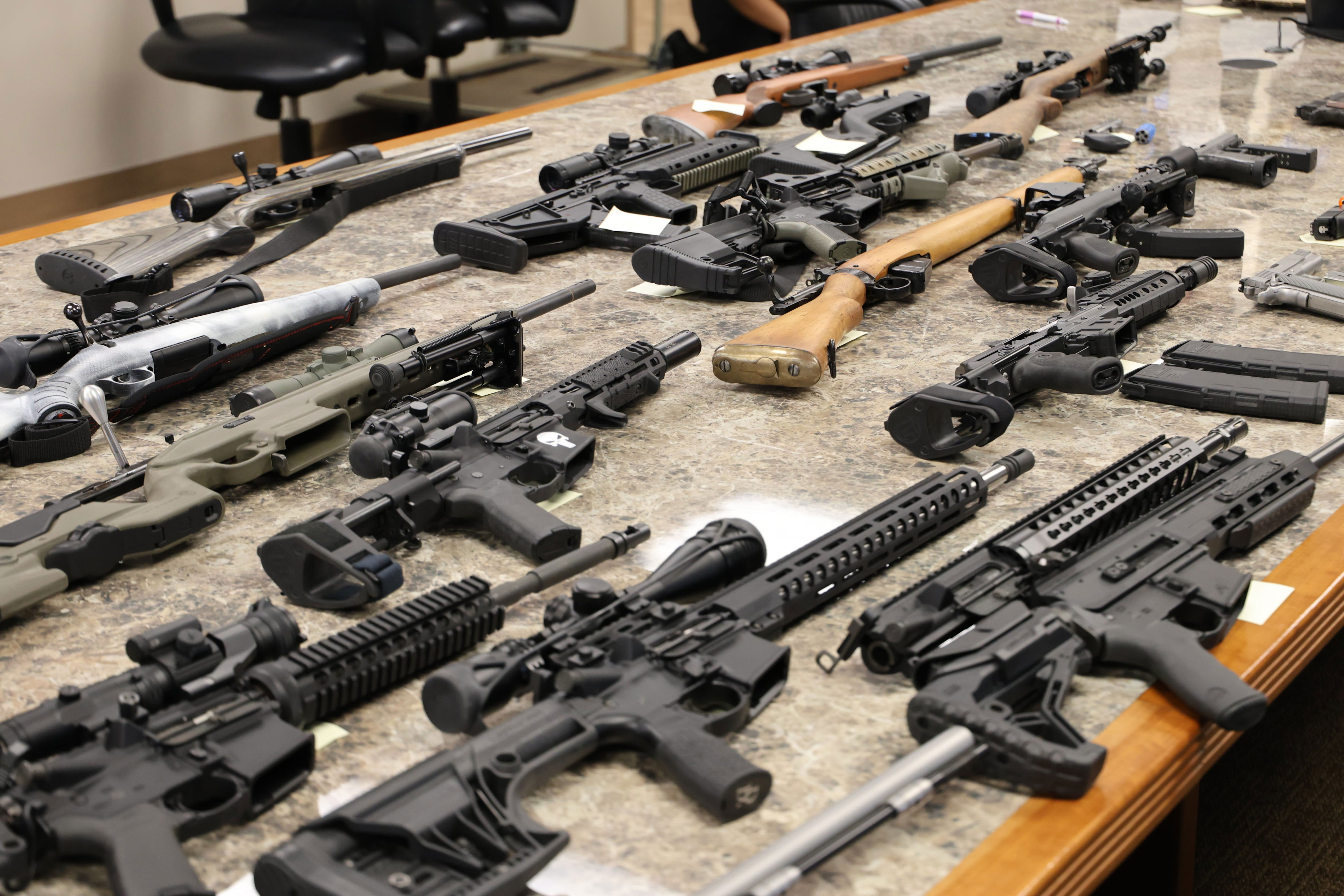 Man charged after nearly 30 guns, thousands of rounds of ammunition ...