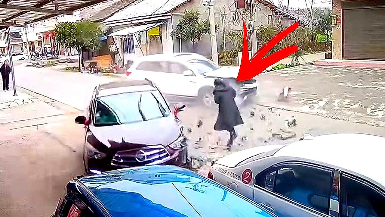 Cars collide violently as pedestrian stands in their path