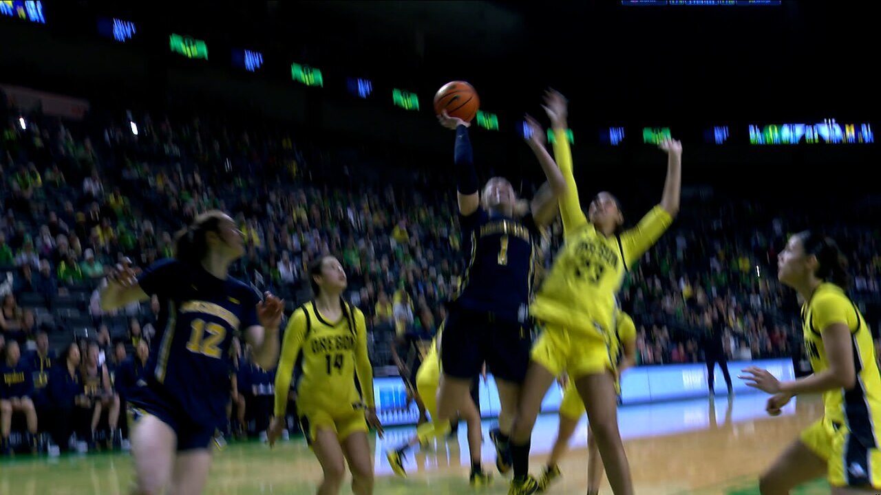 Michigan's Olivia Olson drives right for clutch and-one finish, sending ...