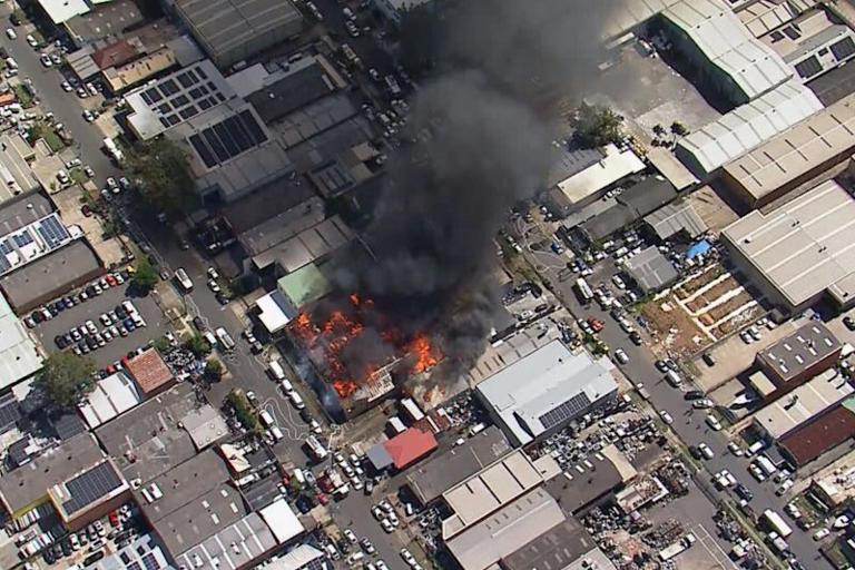 Firefighters battle enormous blaze at factory in Sydney’s south-west
