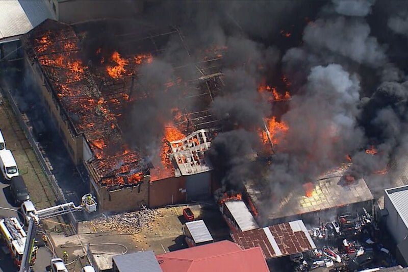 Firefighters battle enormous blaze at factory in Sydney’s south-west