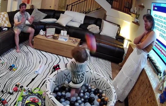 Baby stuns dad with perfect spiral American football throw
