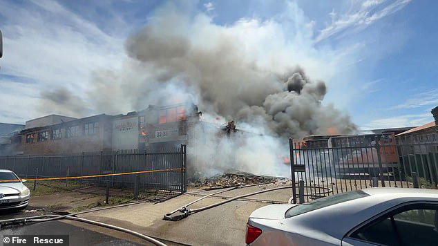 Huge factory fire erupts in Sydney sending a massive plume of thick ...