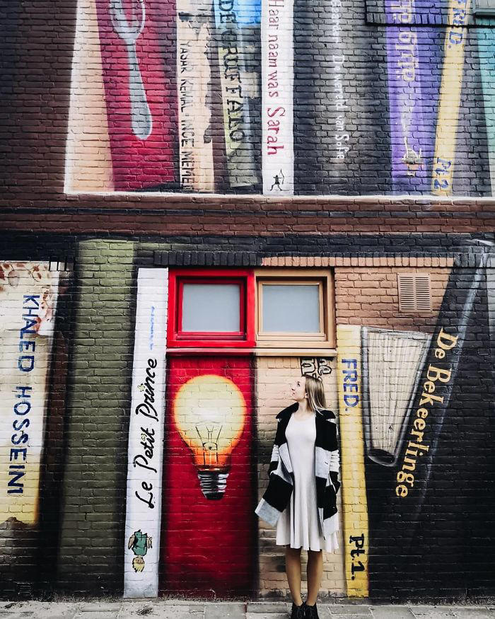 Dutch artists paint giant bookcase on an apartment building featuring ...
