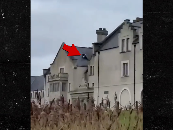 Paraglider crash-lands on hotel roof, dangles dangerously, on video