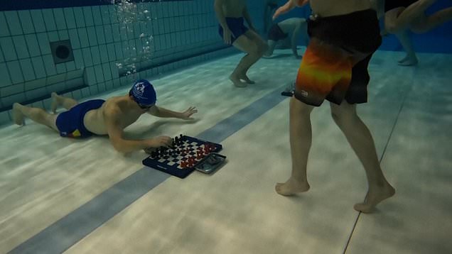 Diving chess players battle it out on submerged chess boards
