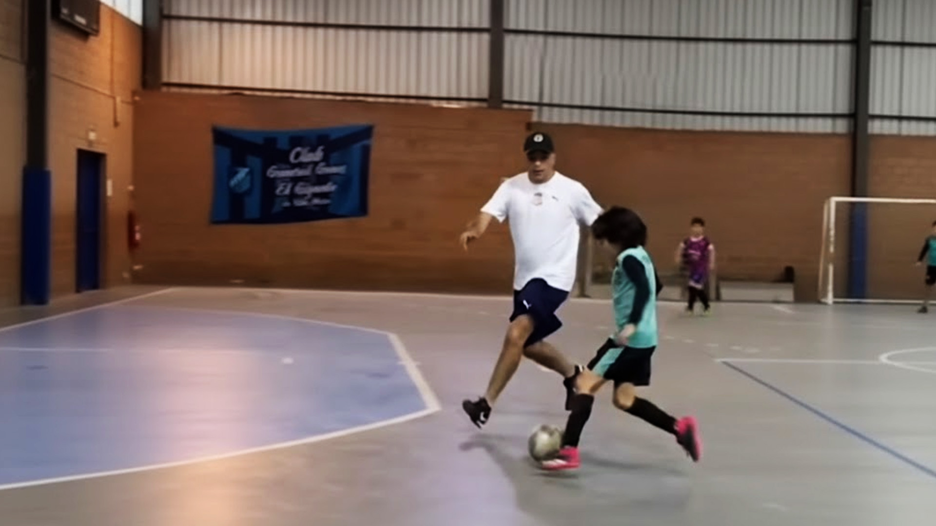 Young child shows dribbling skills against adult