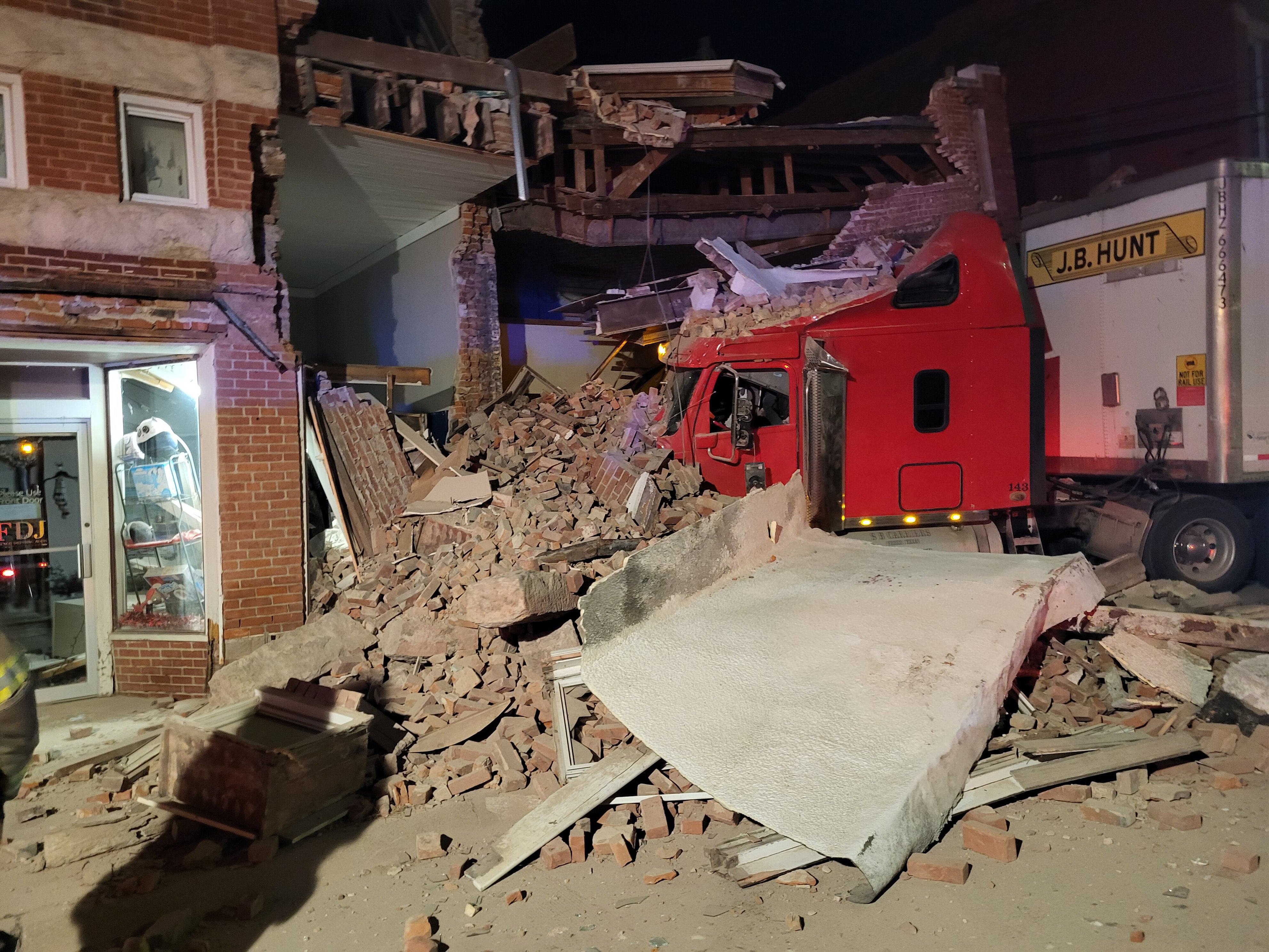 Authorities advise caution after semi truck crashes into building in Auburn