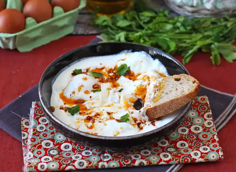 Turkish-style eggs on a yogurt base with spicy oil - çilbir