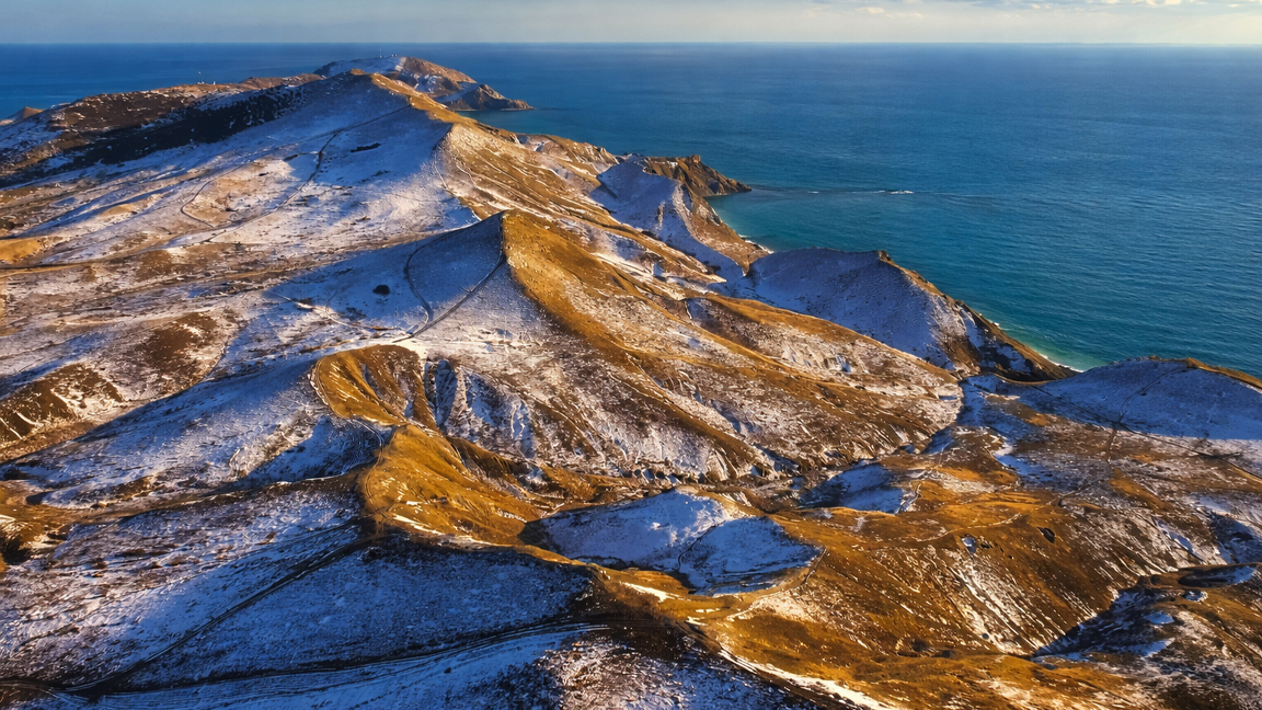 Winter sunlight over coastal ridge views
