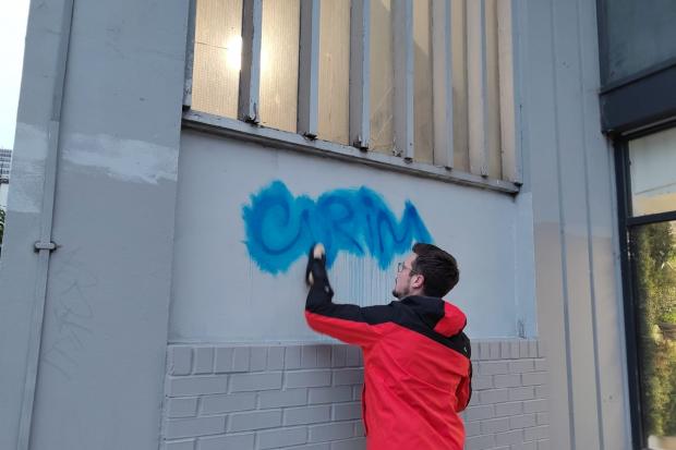 Councillor helps to clean graffiti from new bus stops