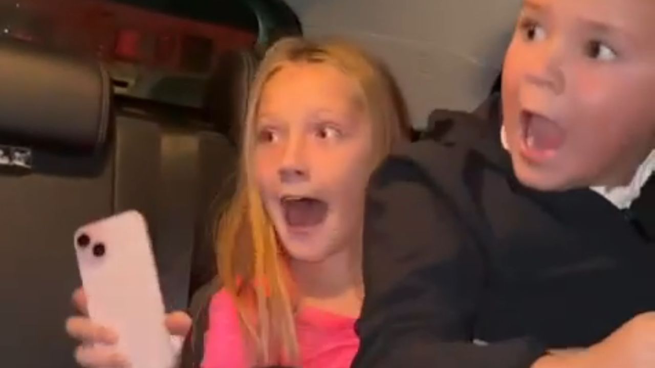 Kids scream loudly as an eerie figure jumps into their car at horror ...