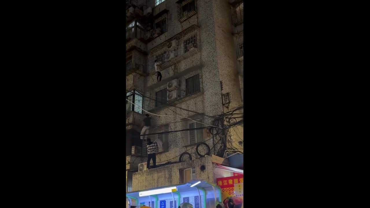 Child rescued from building window grill in Shanghai, China
