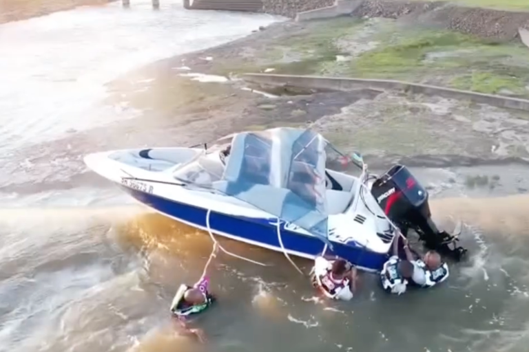 Watch: Men cling to boat as it dangles over edge of 130ft dam