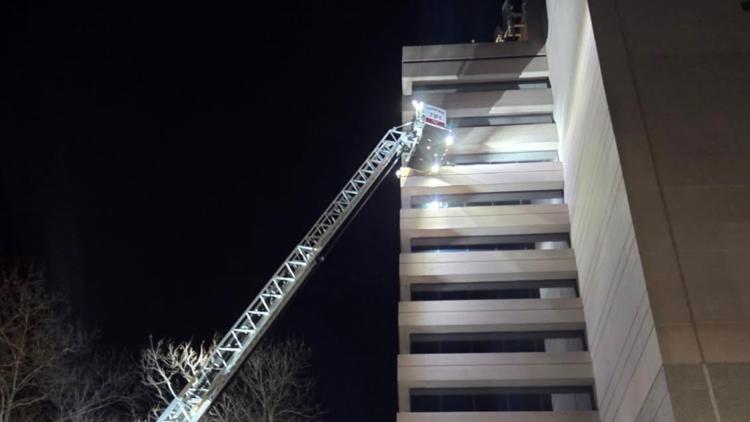 Men rescued from hotel ledge after escaping armed robbery, police say