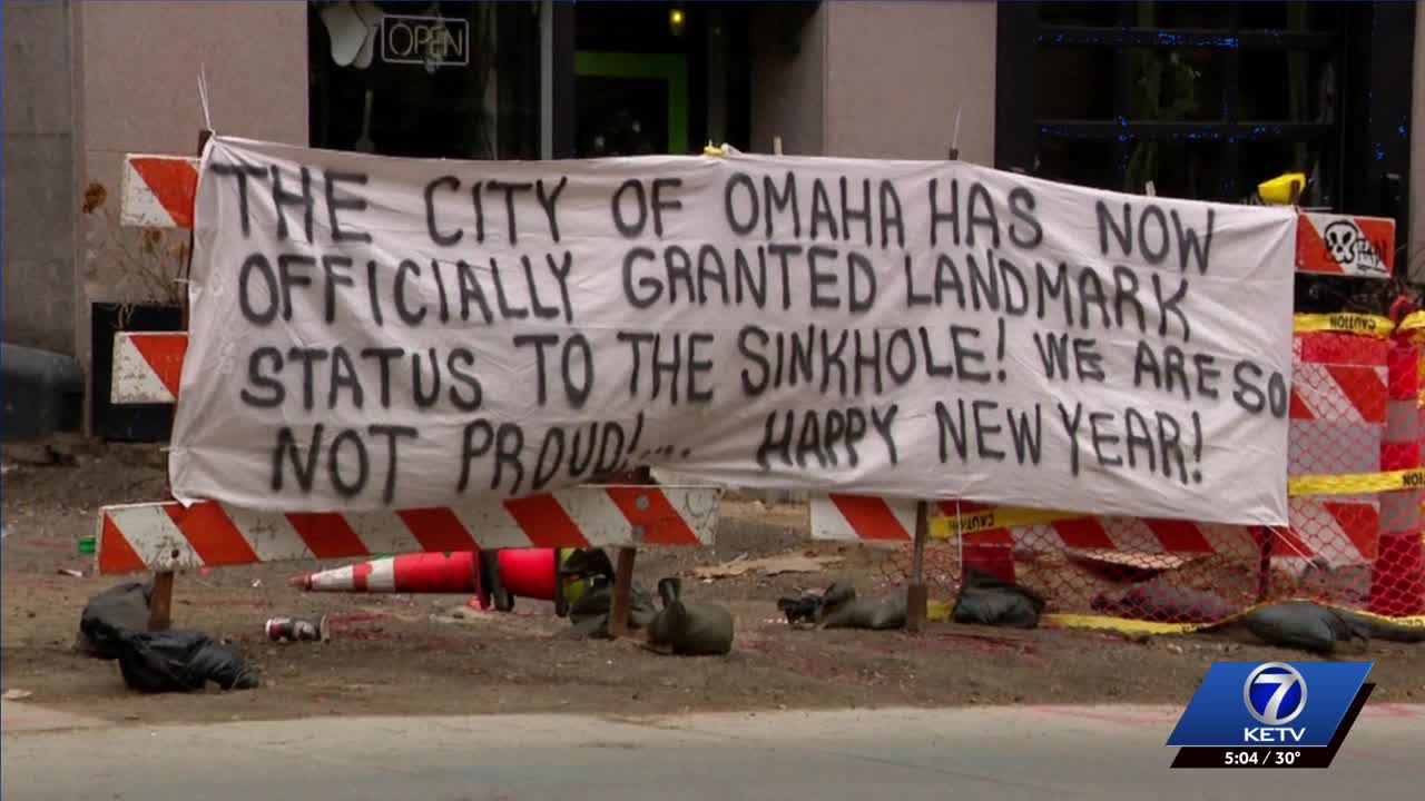 'Granted landmark status': New sign hangs on downtown Omaha sinkhole's ...