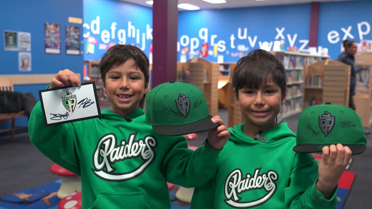 Raiders players swap hockey sticks for storybooks at Prince Albert library