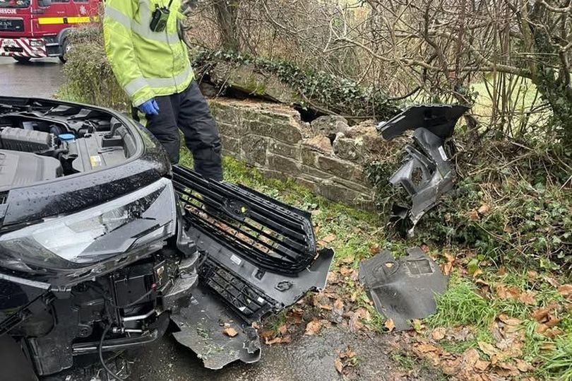 Person trapped in car after crashing into a bridge