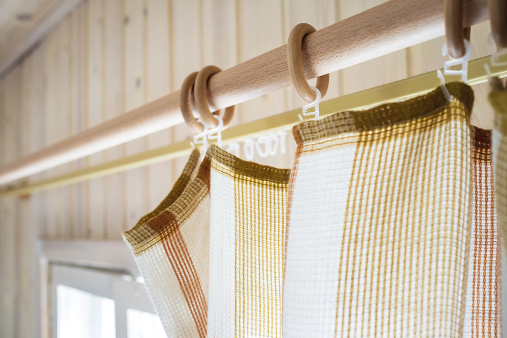 How to hang curtains to make windows look bigger