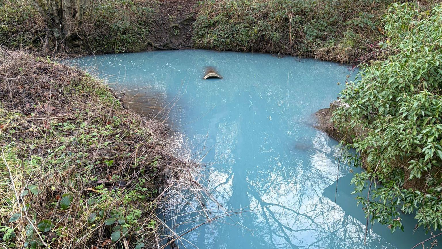 Bright blue 'paint' appears in waterway