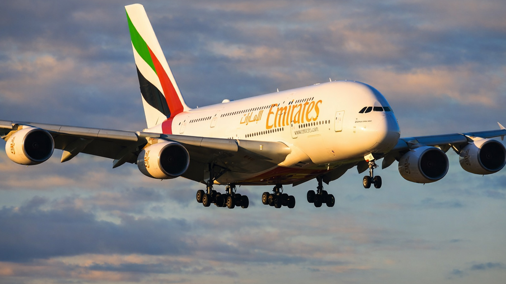 Giant passenger jets emerging from the clouds