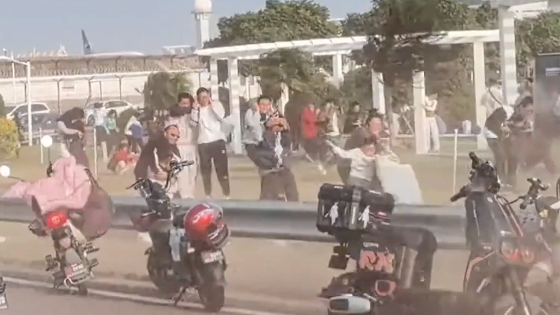 Plane spotters struggle to stay upright as departing jet blast hits crowd