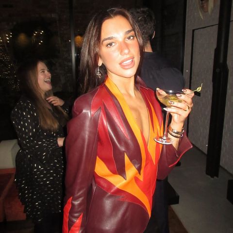 Dua Lipa looks like literal fire in a plunging flaming leather top and ...